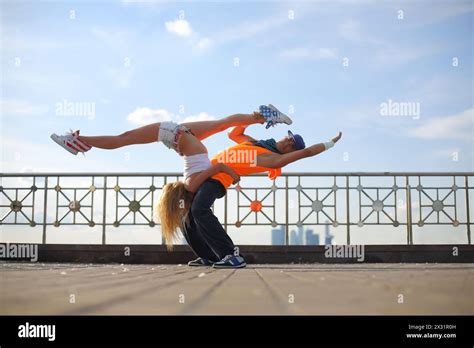 Young Couple Dancing Modern Dance In The Street Girl Do The Splits