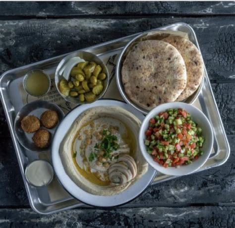 Vaggi Salad 1 Pita Bread 3 Falafel Balls 1 Boild Egg And A Humus Plate With Some Olive Oil