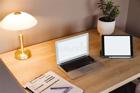 Modern Workplace With Laptop And Tablet With White Blank Screen Stock