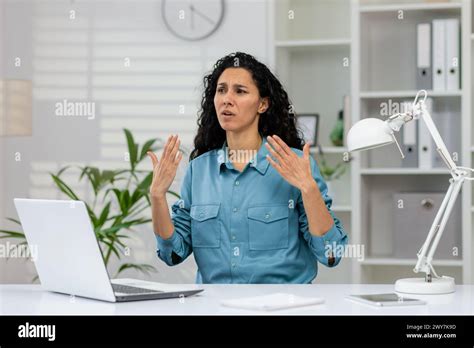 An Uncomfortable Businesswoman Feeling Too Hot In An Office Setting