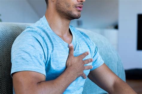 Premium Photo Midsection Of Biracial Man Sitting On Floor In Bedroom Meditating With Deep