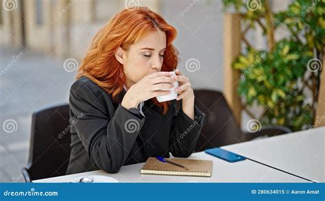 Young Redhead Woman Business Worker Drinking Cup Of Coffee At Coffee