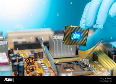 Electronic Engineer Hand Putting Computer Chip On Socket Chipset On Electronic Circuit Board Of