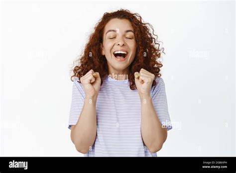 Relieved Redhead Girl Fist Pump Smiling Delighted With Clenched Fists Celebrating Victory
