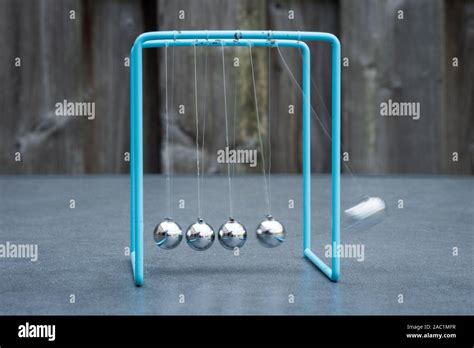 Newtons Cradle Physics Experiment Collision Balls In Action Blurred