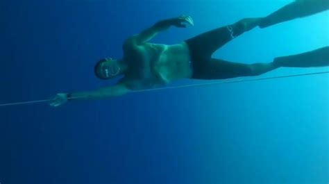 Skinny Barefaced Freediver Diving Deep Underwater