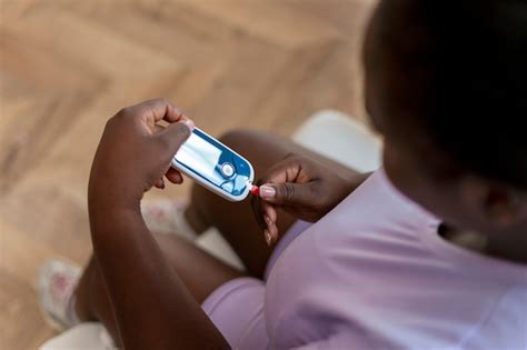 High Angle Diabetic Woman Checking Her Glucose Level Free Photo