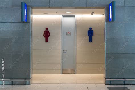 Front View Of Public Restroom Or Toilet With Man And Women Signs On Marble Wall Way To Clean