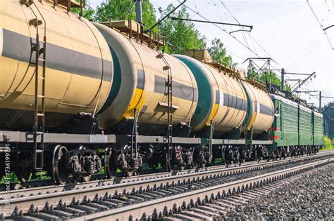 The Train Is Moving Along The Railway Tracks The Tank Car Is Pulled By