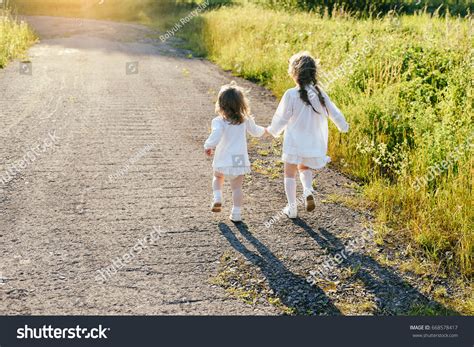 Little Sisters Holding Hands