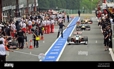 Formula One Cars Drive In The Pit Lane During The Second Practice