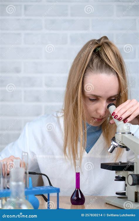 The Laboratory Assistant Examines Samples Of Materials Under A