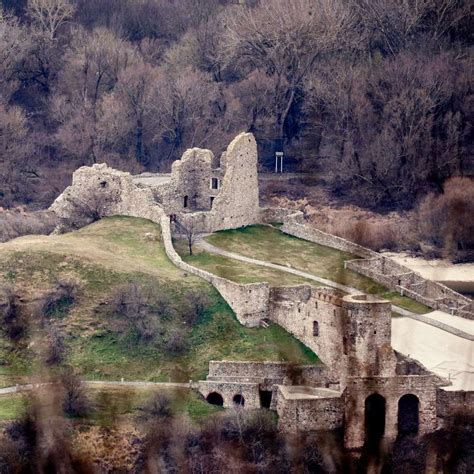 Gray Concrete Building Near Green Grass Field And Body Puzzle Factory