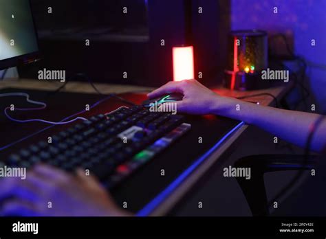 female cyber hacker gamer using keyboard and mouse to playing games or