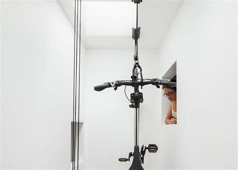 Bicycles Stored On A Pulley System In House Atrium By Tribe Studio