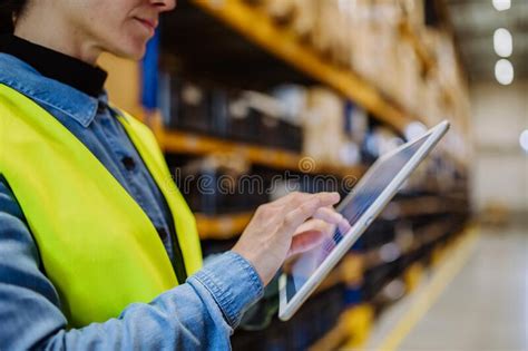 Warehouse Female Worker Checking Up Stuff In A Warehouse Stock Image