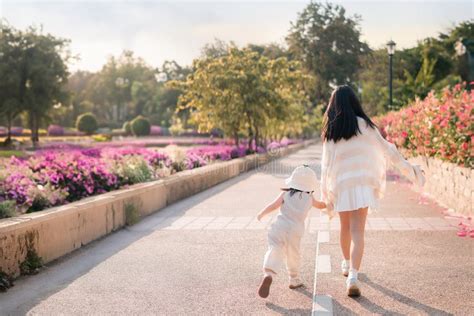 Happy Asian Old Sister And Young Asian Sister Walking Hand In Hand