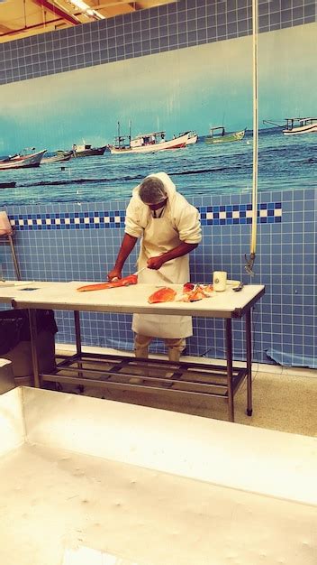 Premium Photo Man Cutting Fish