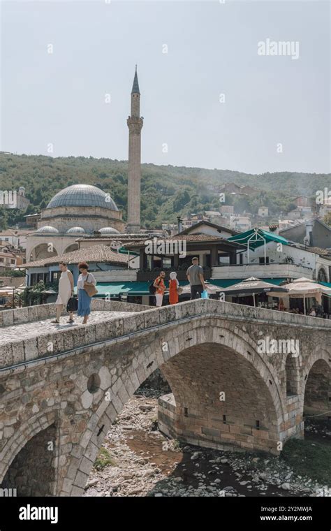 Tourists And Locals On The Old Stone Bridge Over The Bistrica River In