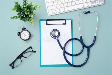 Doctor Desk With Stethoscope Clipboard And Computer Keyboard On Blue