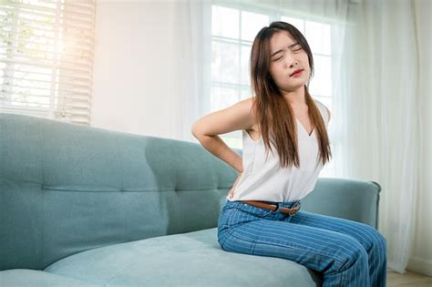 Premium Photo Asian Woman Holding Her Lower Back Feeling Painful