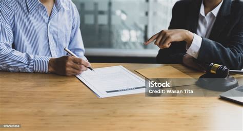 Female Lawyer Is Explaining The Terms Of The Legal Contract Document