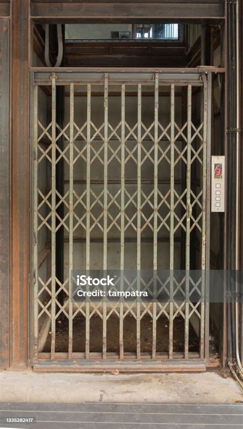 A Classic Old Elevator Lift With Collapsible Gate In Hotel Interior
