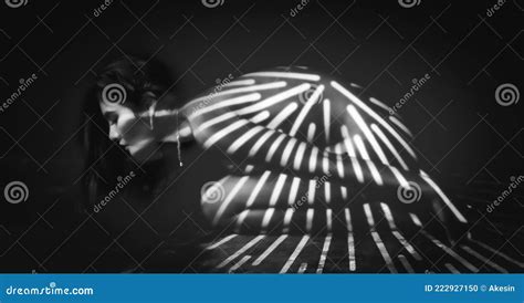 Nude Art Of Naked Woman With Light And Shadow Strip On Dark Background