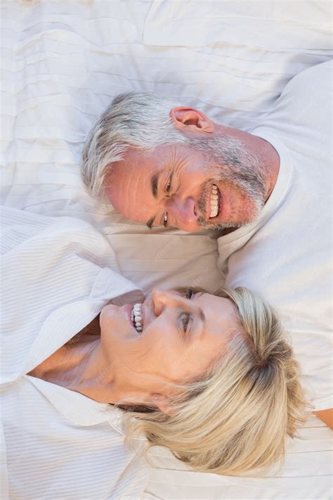 Premium Photo High Angle Portrait Of A Happy Mature Couple In Bed