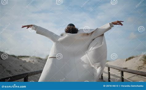 Girl Spread Arms Open At Windy Beach Rear View Relaxed Woman Enjoying