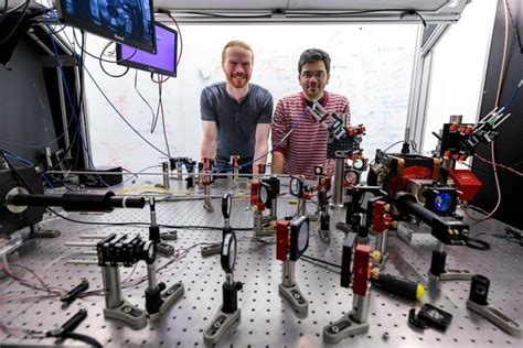Combining Atom Arrays And Photonic Devices For Scalable Quantum Systems