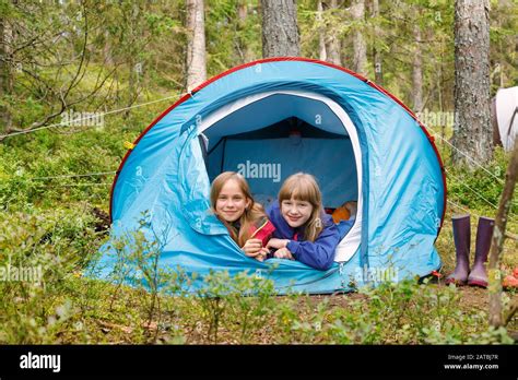 Tween Girls Lying Together In Tent Enjoying Camping In A Summer Forest