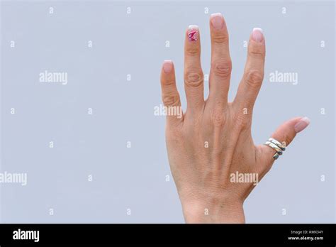 Hand Of An Older Woman With Manicured Nails Wearing A Silver Thumb Ring