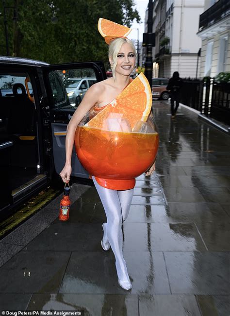 Pixie Lott Goes All Out For Halloween By Dressing Up As An Aperol Spritz As She Arrives At