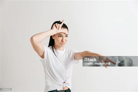 Losers Go Home Portrait Of Woman Showing Loser Sign Over Forehead Stock