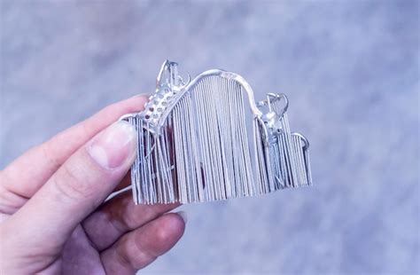 Premium Photo Man Is Holding Object Printed On Metal 3d Printer