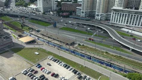 An Aerial View Of A Busy Highway Next To The Railway Station And Urban