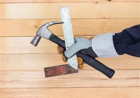 Premium Photo Cropped Image Of Person Holding Hand Tools On Table