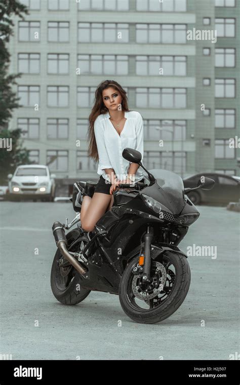 Biker Girl Rides A Motorcycle In The Rain First Person View Stock