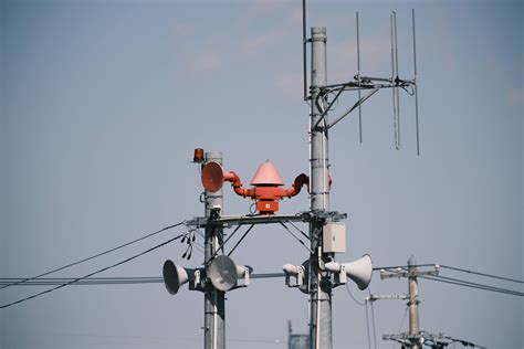 A Red Fire Hydrant Sitting On Top Of A Metal Pole Photo Free Aomori