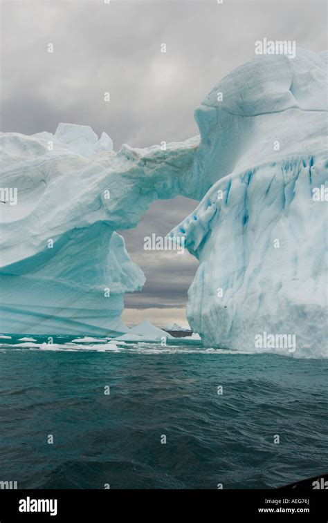 Arched Iceberg Floating Off The Western Antarctic Peninsula Antarctica