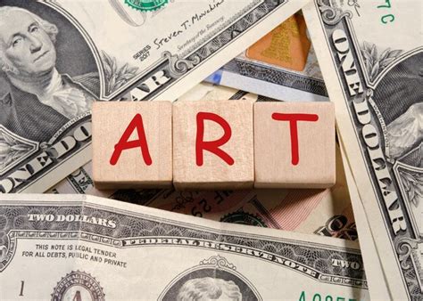 Premium Photo The Word Art Written In Red On Wooden Cubes Over Dollar