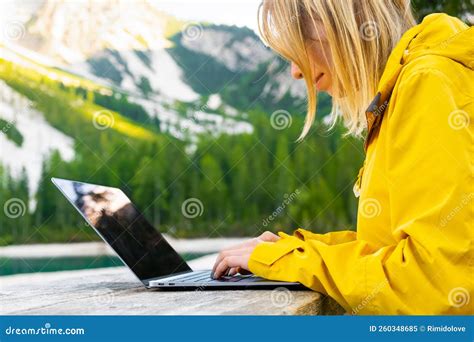 The Girl Is Focused On Working At A Computer In Nature With A Beautiful