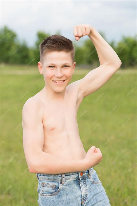 Premium Photo Portrait Of Shirtless Boy Smiling While Flexing Muscles