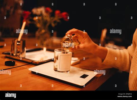 Pouring Melted Wax Into Glass Set For Crafting Candle On Metal Tray