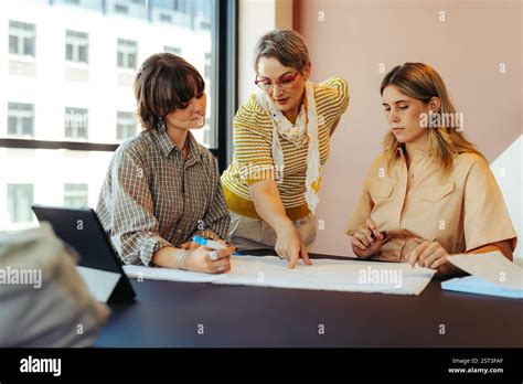 Professor Guides College Students In A Modern Classroom Fostering A