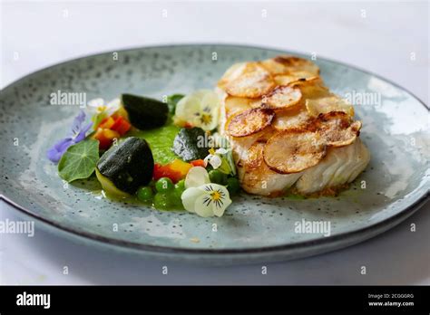 White Fish Fillet With Potato Scale Pea Puree And Summer Vegetable