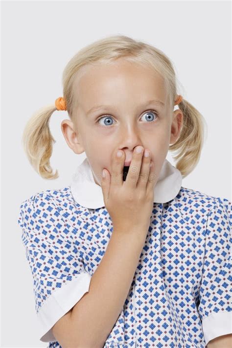 Portrait Of A Surprised Young Girl With Mouth Open Over White