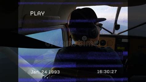 Male Pilot Navigating Cockpit Controls Displaying Flight Data Overlay