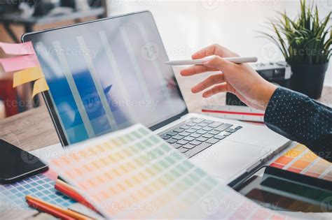 Graphic Designer Architects Who Work With Laptops And Color Comparison Tables For Design Work